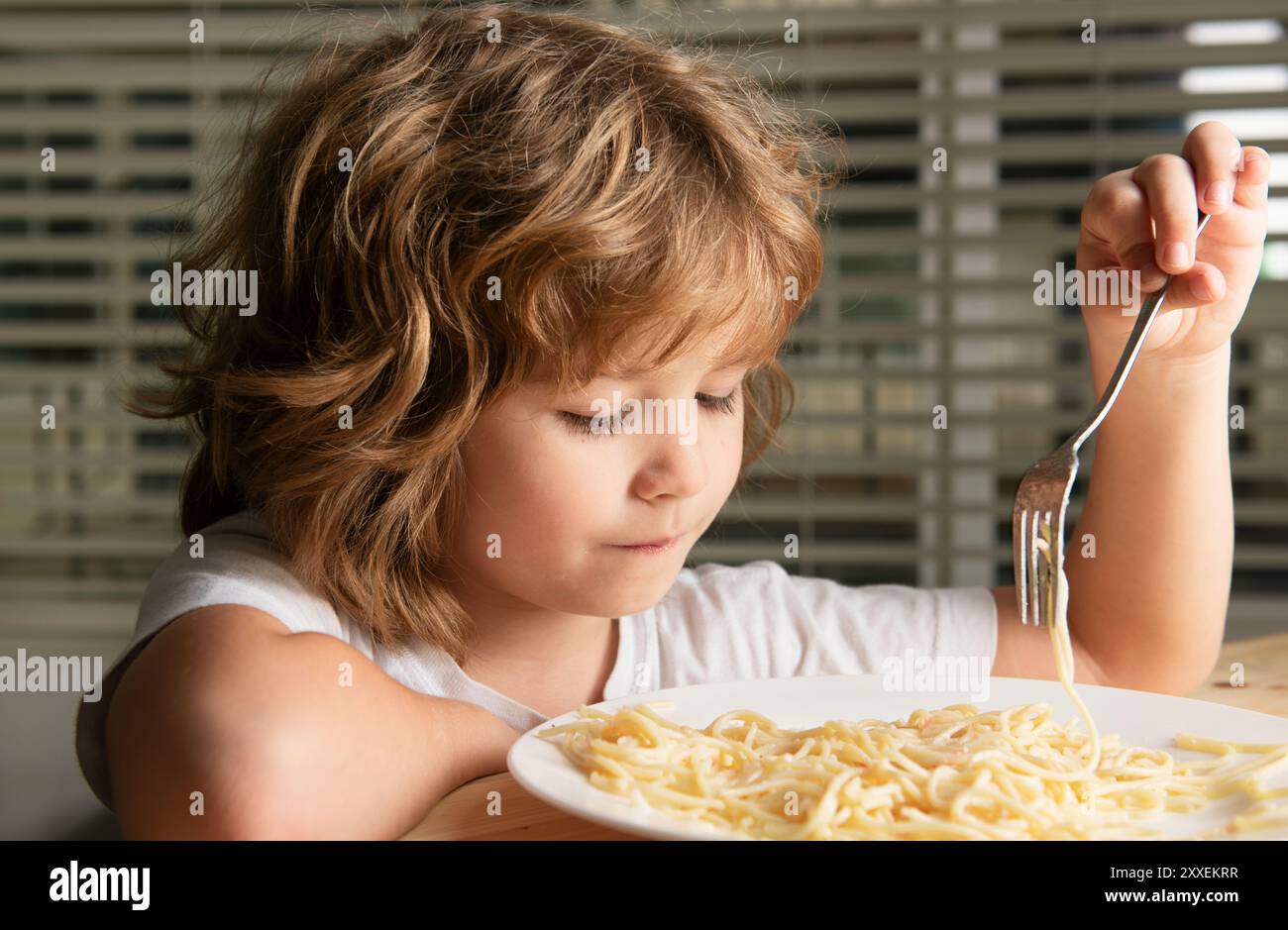 Kid eating pasta, spaghetti, portrait, close up head of cute child ...