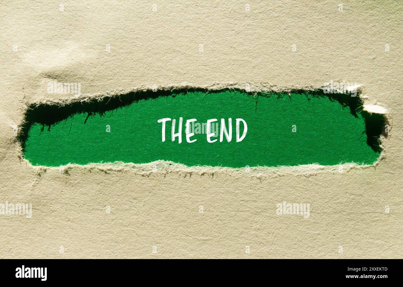 The end message written on ripped torn paper with green background ...
