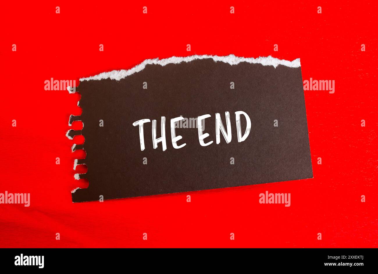 The end message written on ripped torn black paper piece with red ...