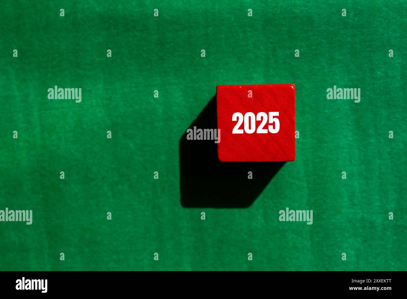 2025 message written on red wooden cube with green background ...