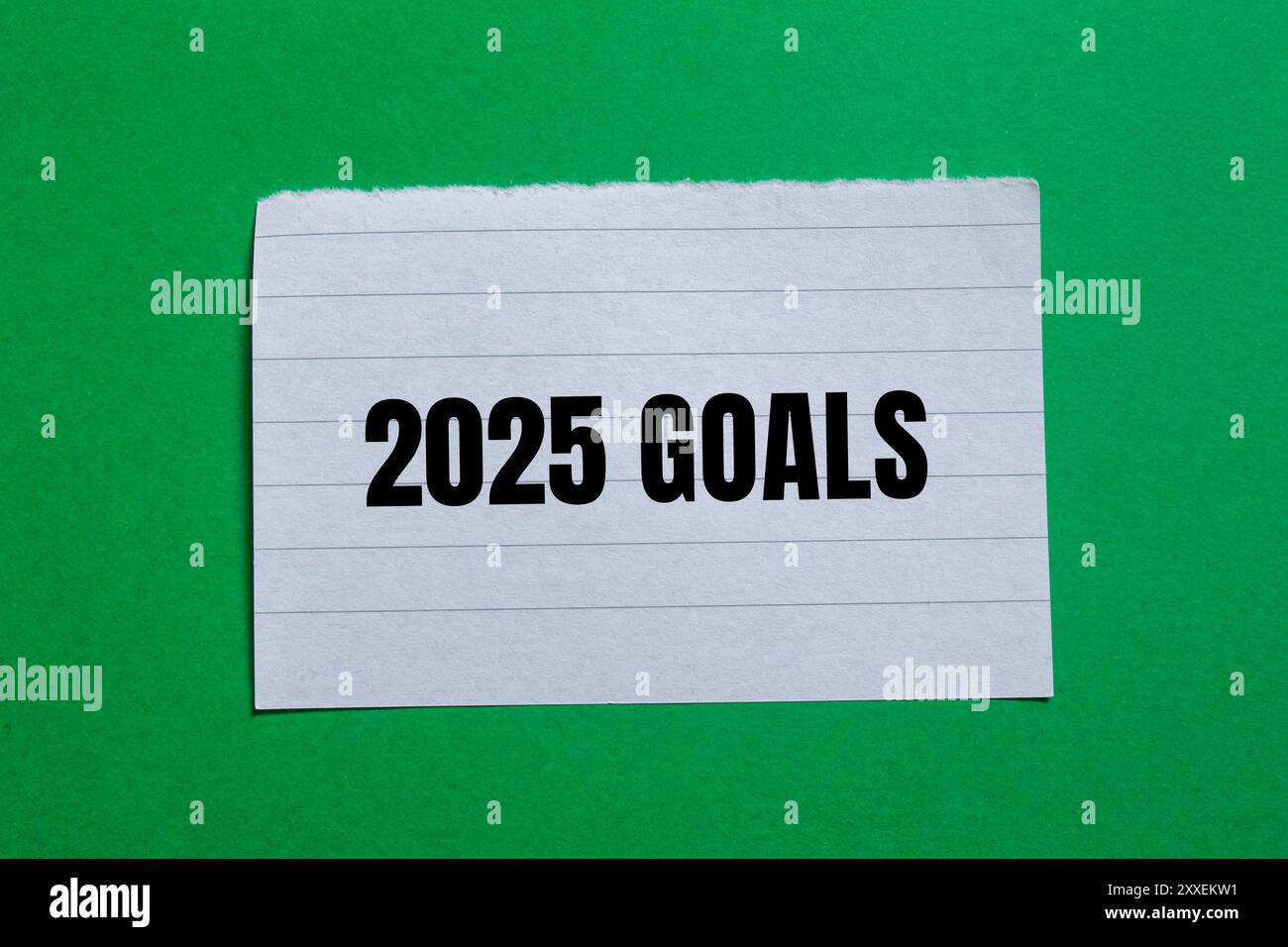 2025 goals message written on ripped torn paper piece with green ...