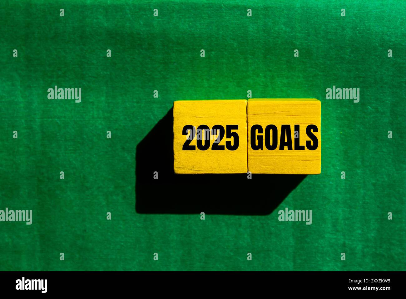 2025 goals message written on yellow wooden cubes with green background ...