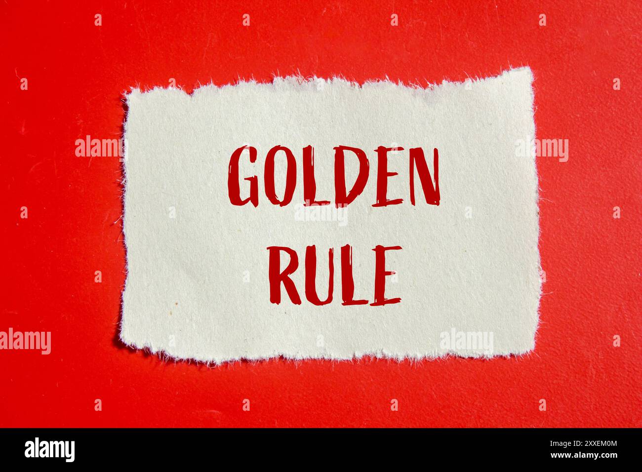 Golden rule message written on ripped torn paper piece with red ...