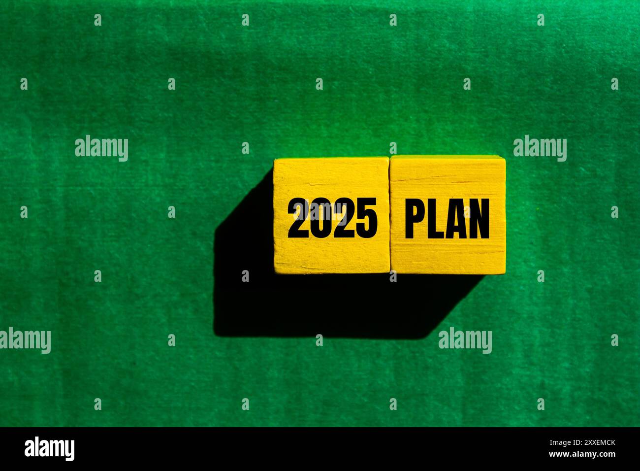 2025 plan message written on yellow wooden cubes with green background ...