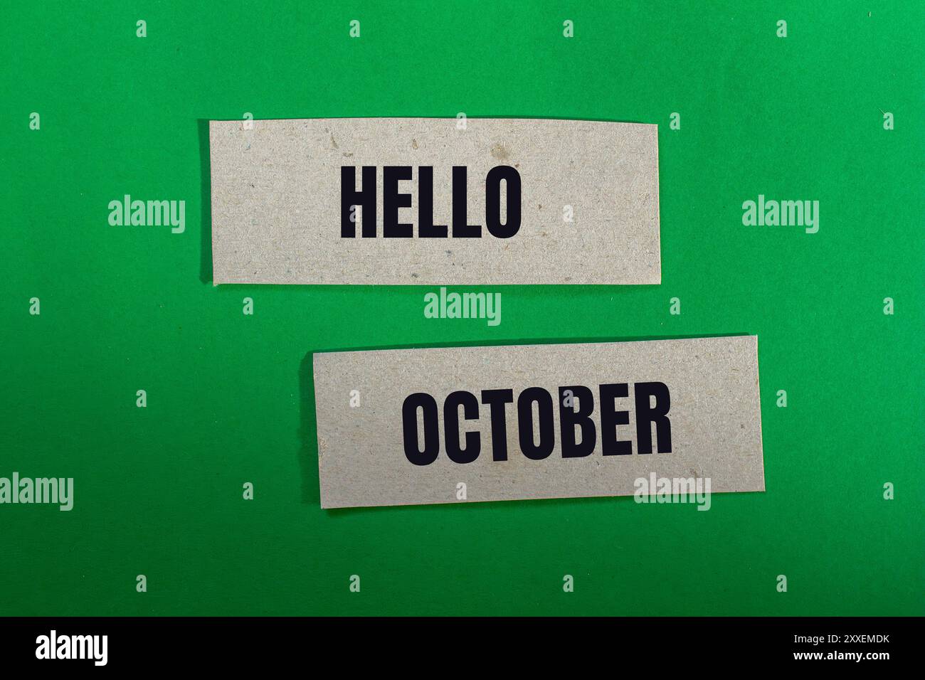Hello october message written on paper pieces with green background ...