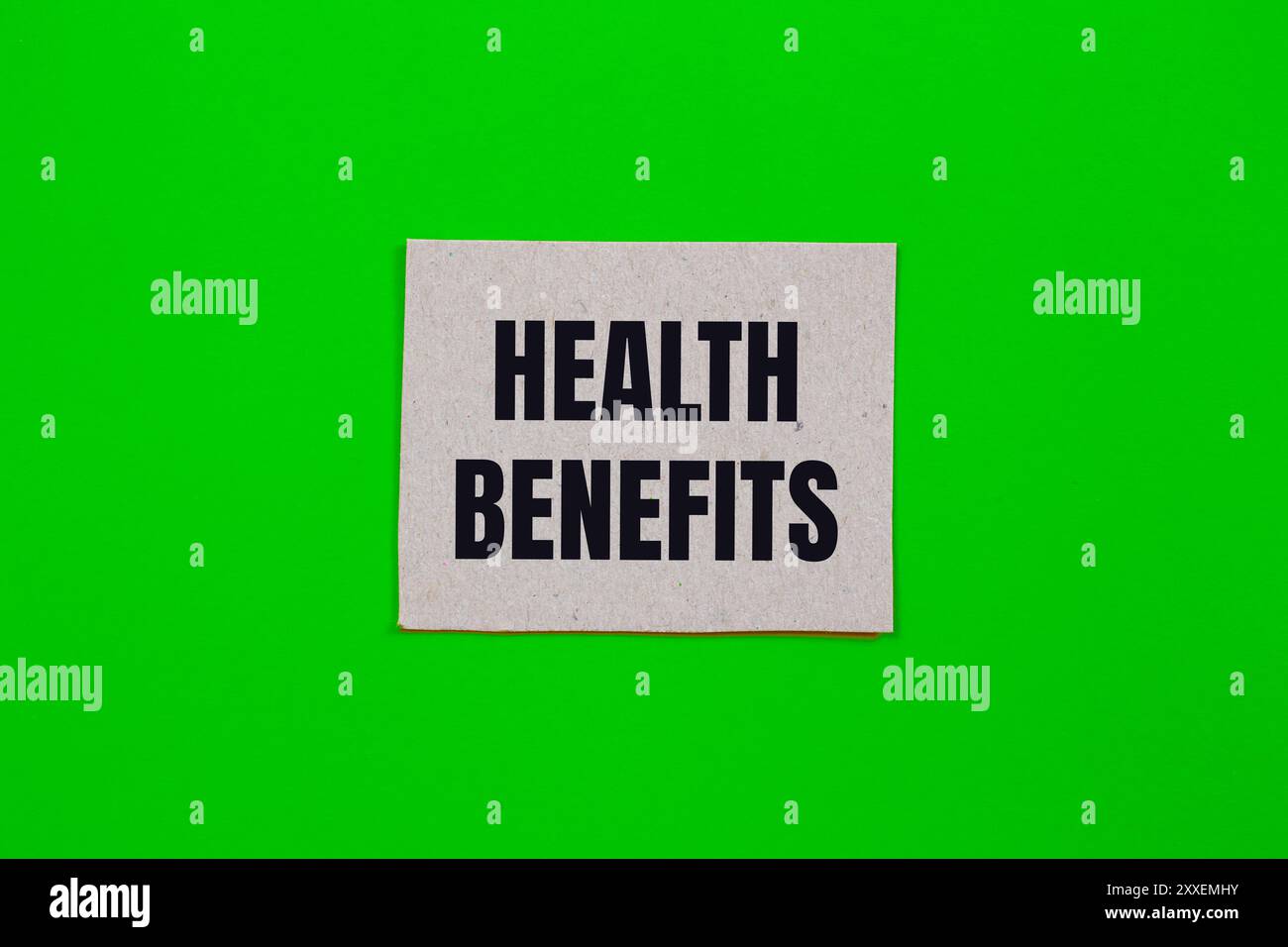 Health benefits message written on paper piece with green background ...