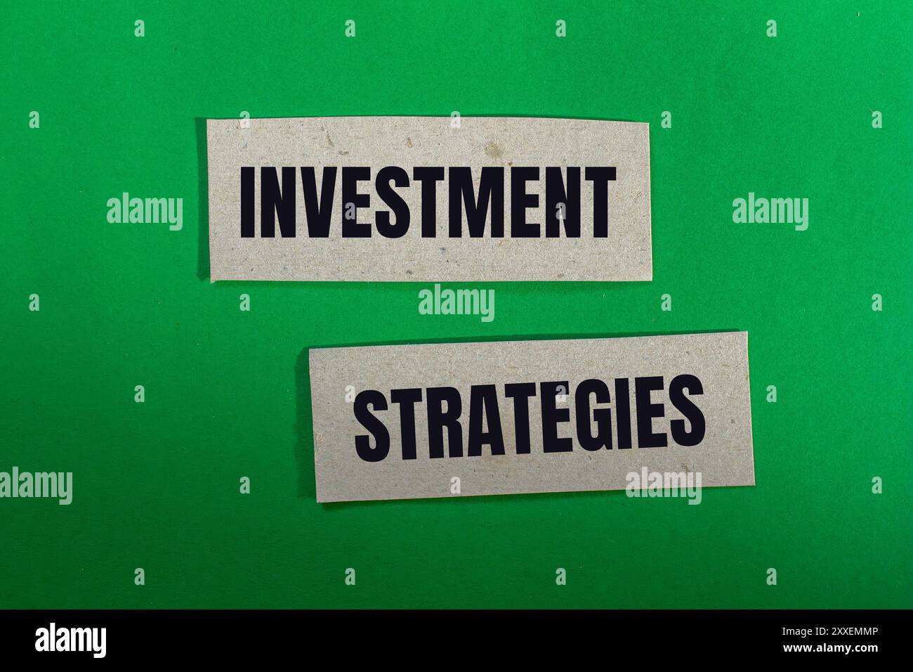 Investment strategies message written on paper pieces with green ...