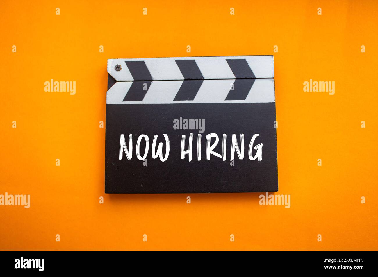 Now hiring message written on movie clapper board with orange ...