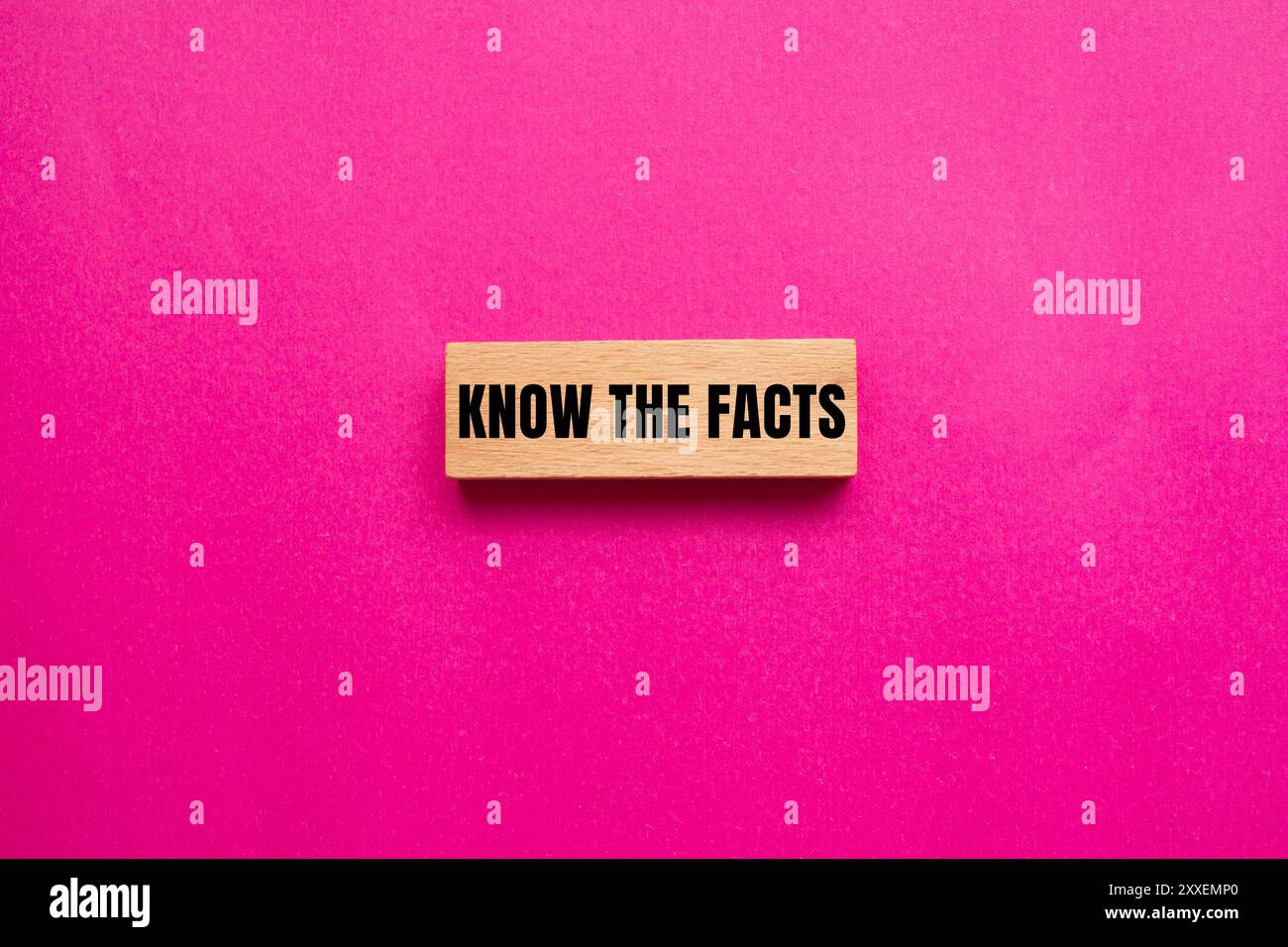 Know the facts message written on wooden block with pink background ...