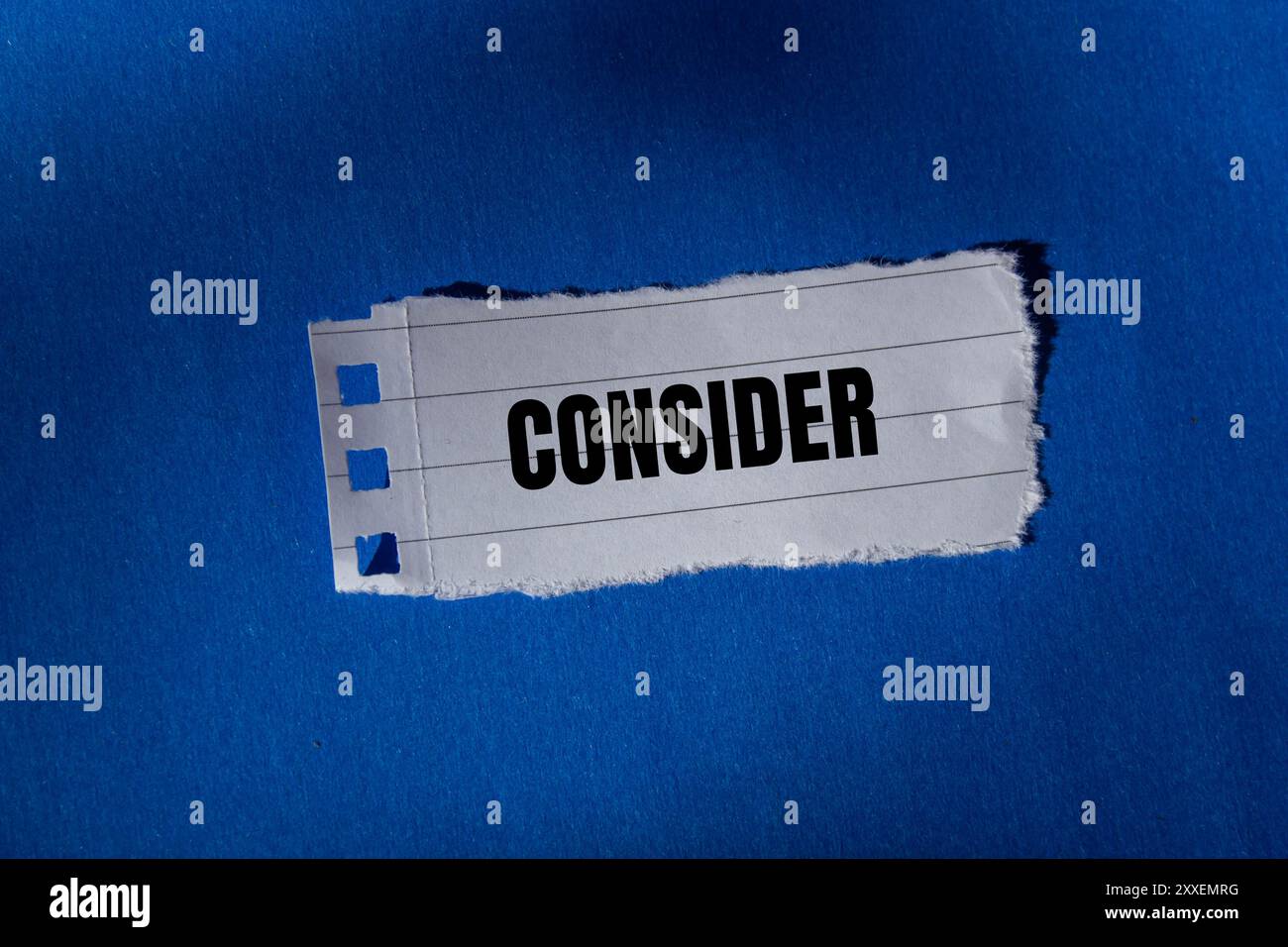 Consider message written on ripped torn paper piece with blue ...