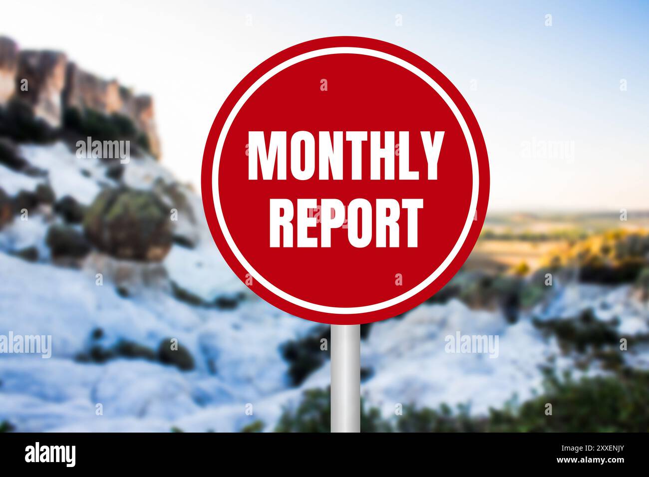 Monthly report message written on red round sign on nature background ...