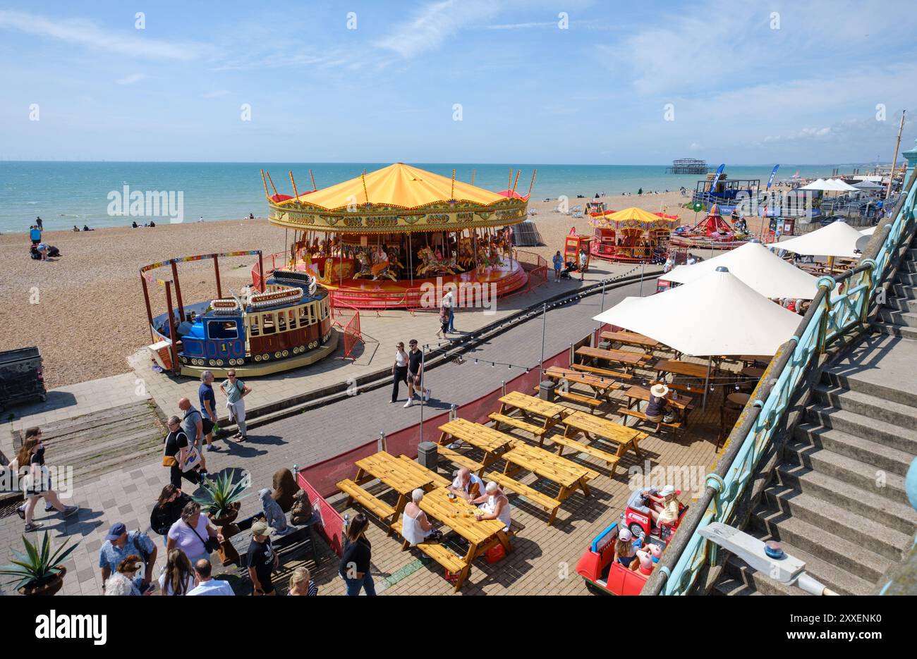 Brighton beach front walk showing fairground carousel horse ride and ...