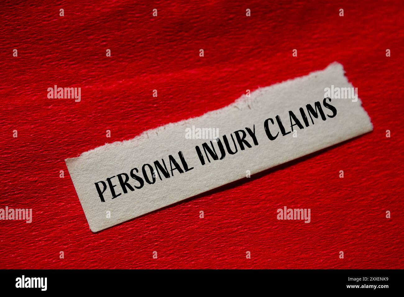 Personal injury claims message written on torn paper with red ...