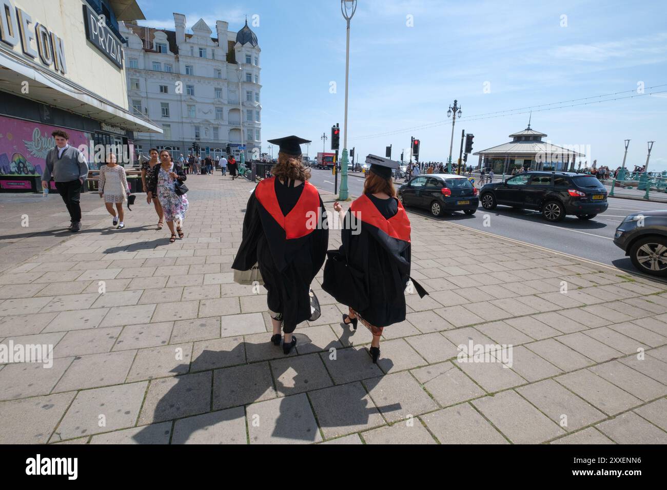 Two Bachelors graduates from the University of Brighton walk along ...