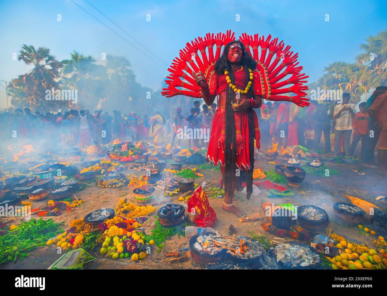 A vibrant ritual scene with a devotee dressed as a fierce deity ...