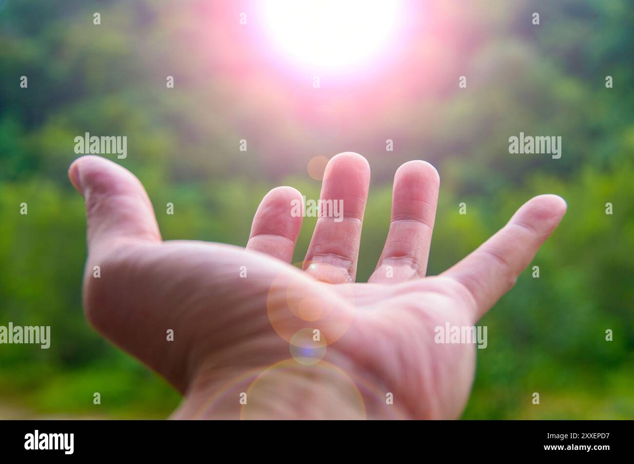 Hand reaching out a shining light representing blessing. Ideas for copy ...