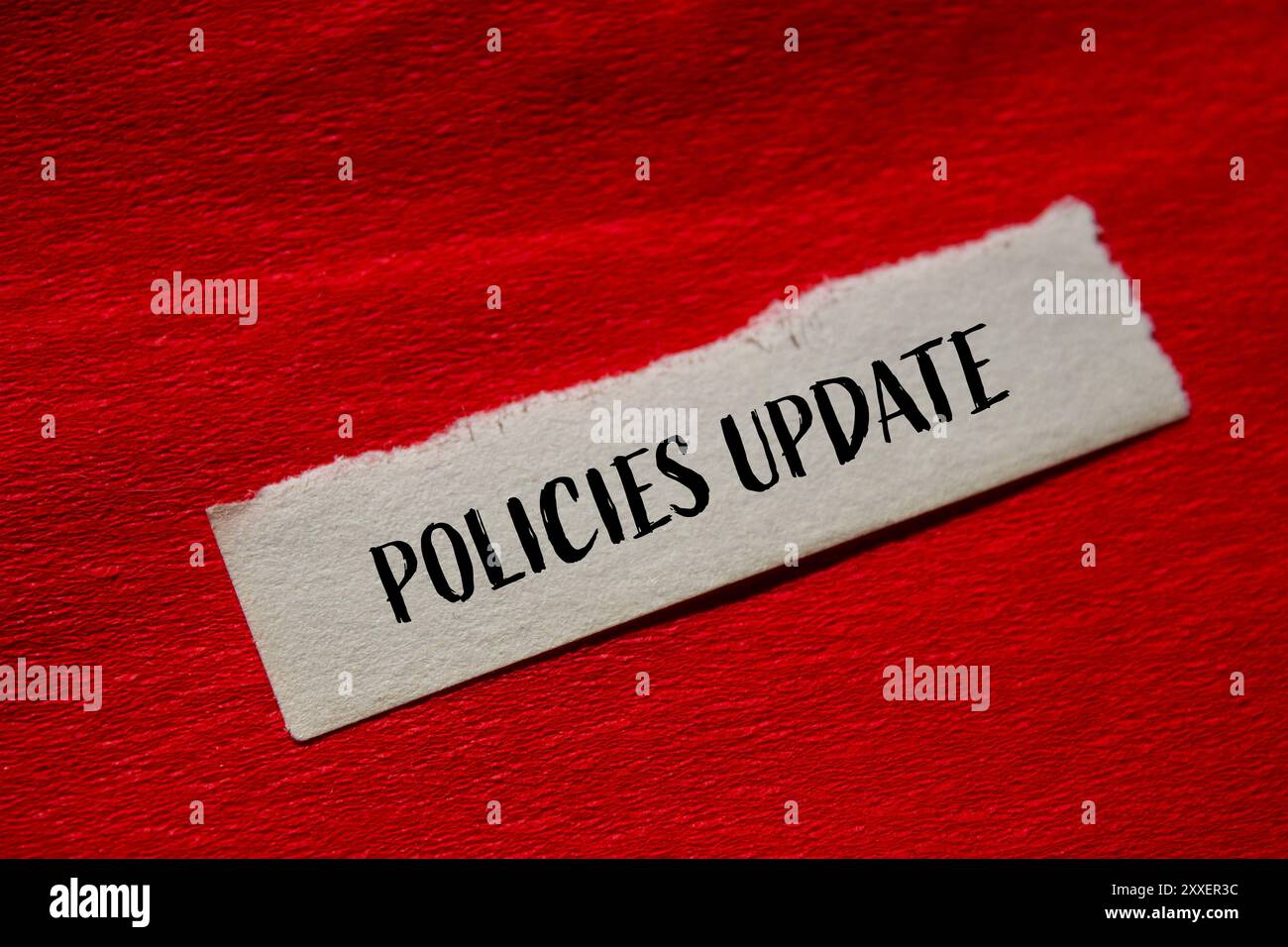 Policies update message written on torn paper with red background. Conceptual policies update ...