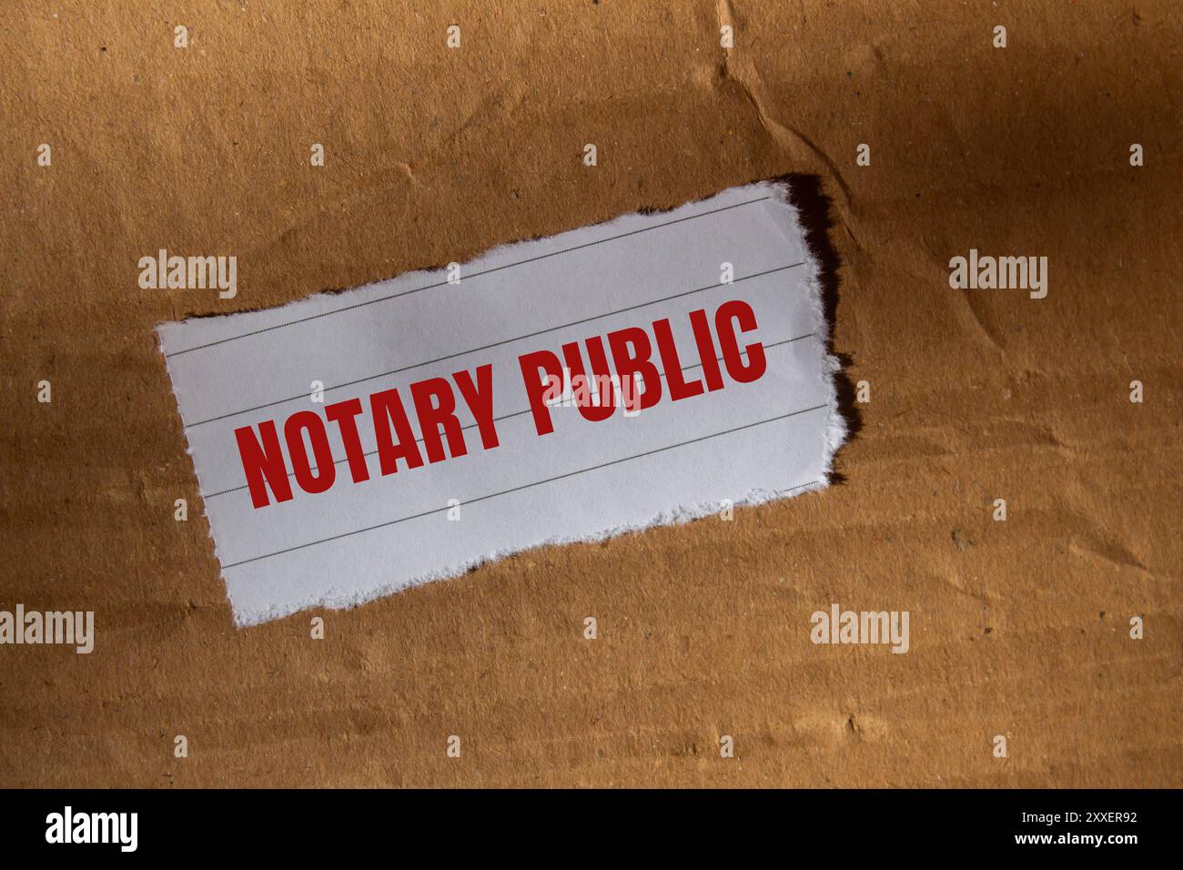 Notary public message written on ripped torn white paper piece with ...