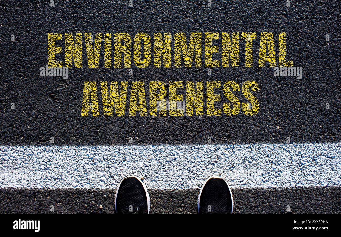 Environmental awareness message written on asphalt road. Conceptual ...