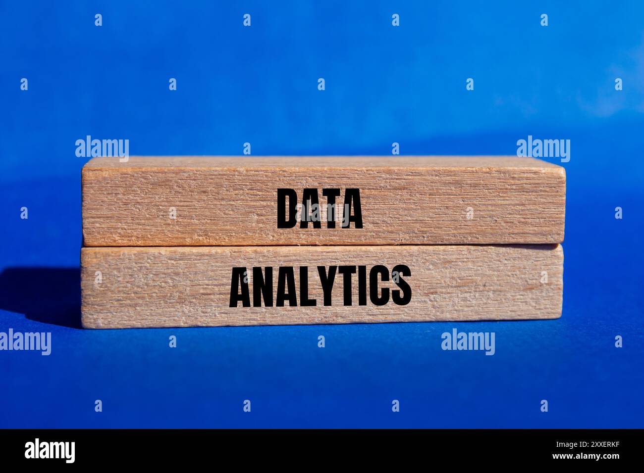 Data analytics message written on wooden blocks with blue background ...