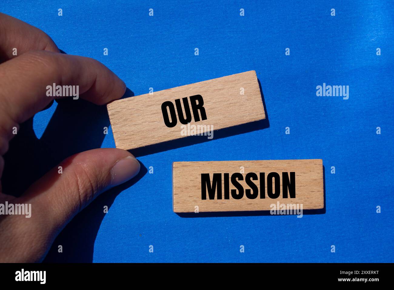 Our mission message written on wooden blocks with blue background ...