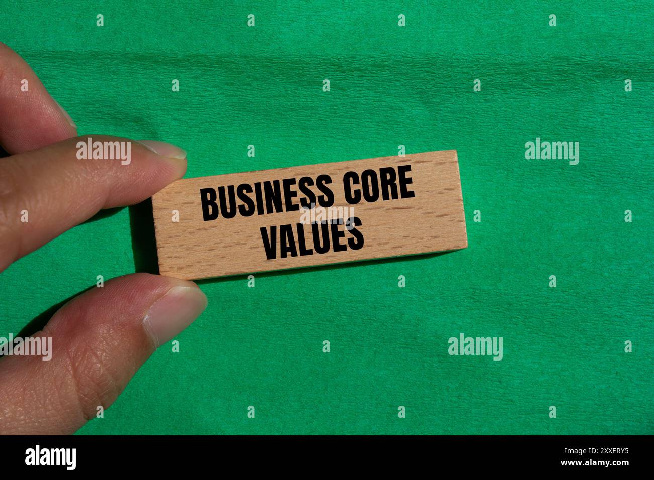 Business core values message written on wooden block with green ...