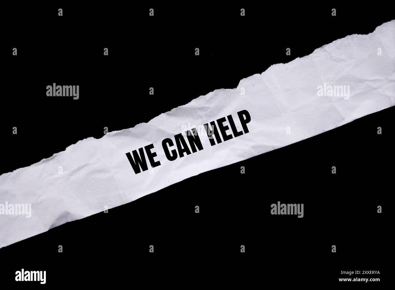 We can help message written on ripped torn white paper with black ...