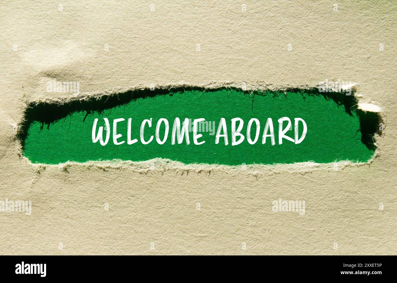 Welcome aboard message written on ripped torn paper with green ...