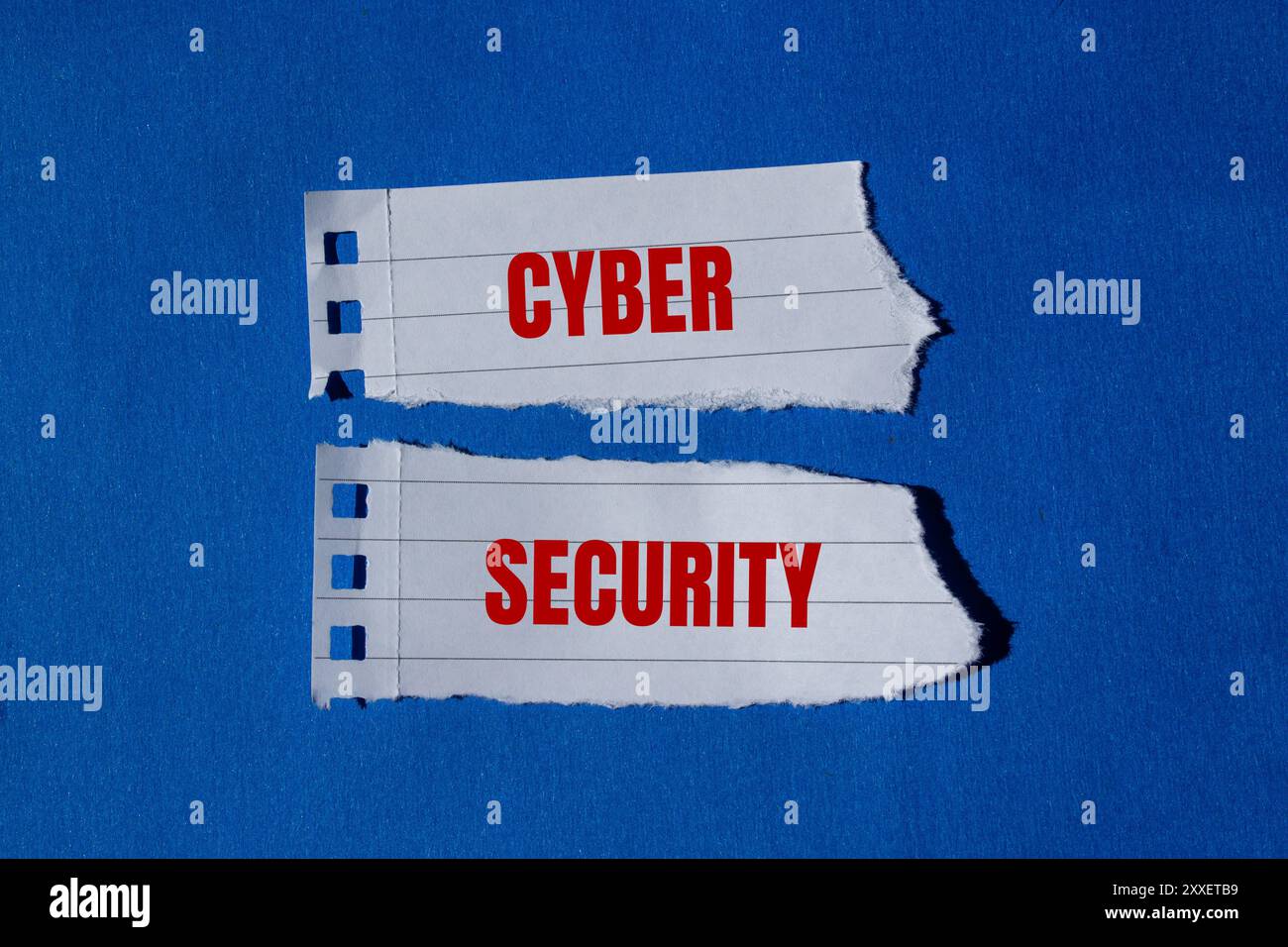 Cyber security message written on ripped torn paper pieces with blue ...