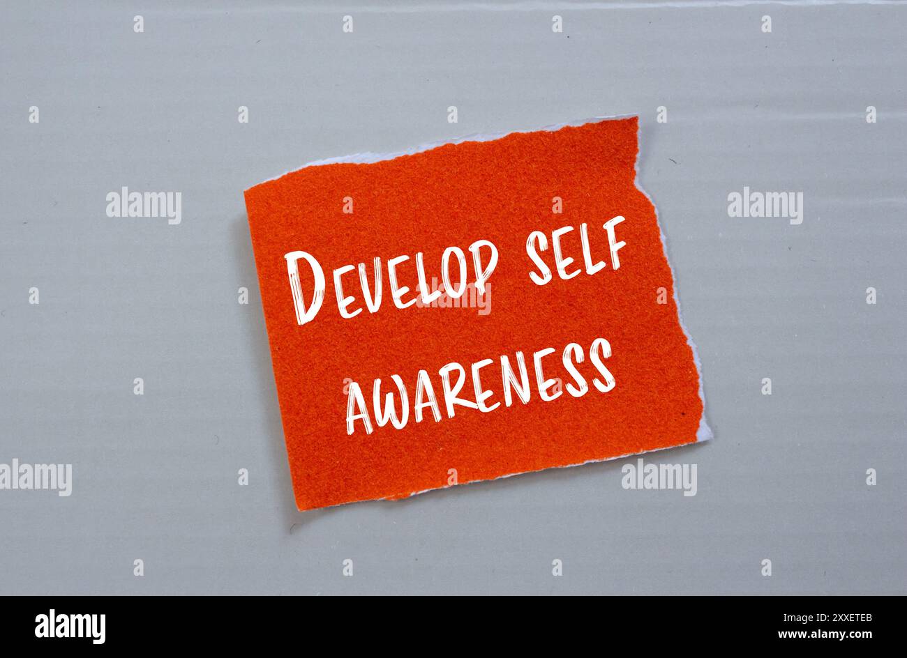Develop self awareness message written on ripped torn orange paper ...