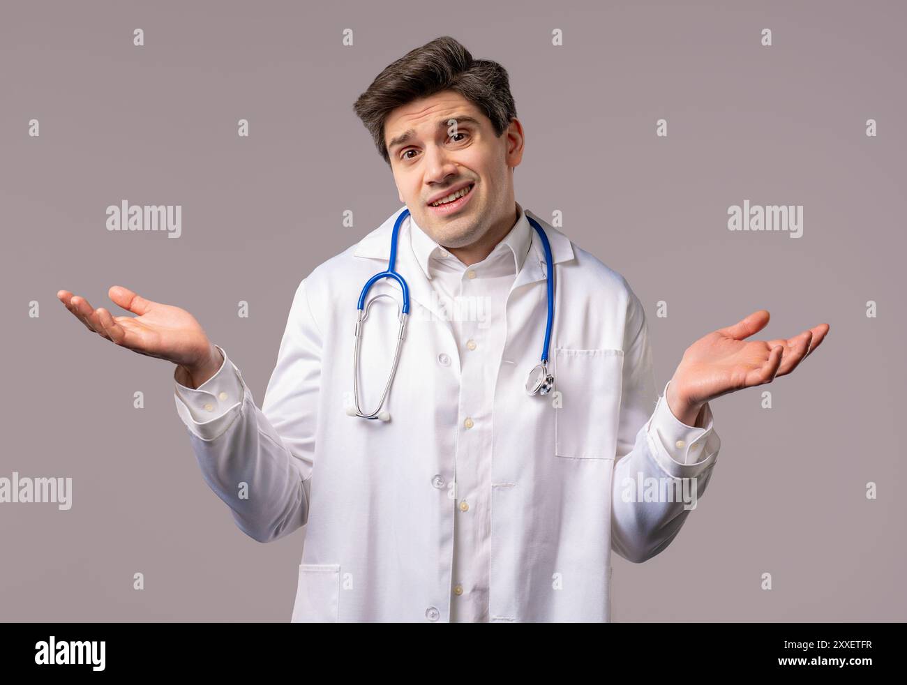 Confused 30s aged physician in white medical coat form, shoulders up ...