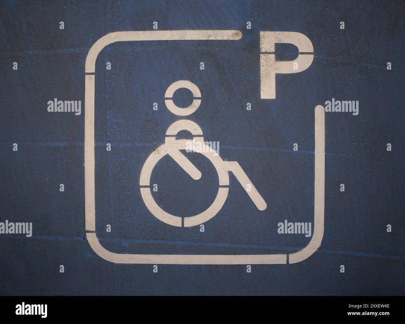 Detail of a sign painted in blue indicating a reserved space for ...