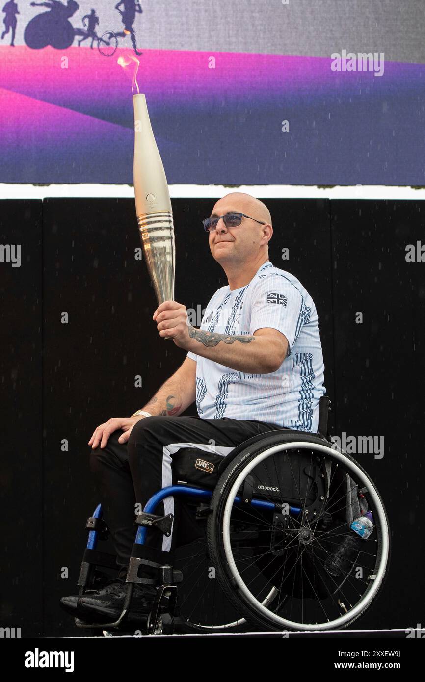 British Paralympian Gregor Ewan holds the Paralympic Torch during the ...