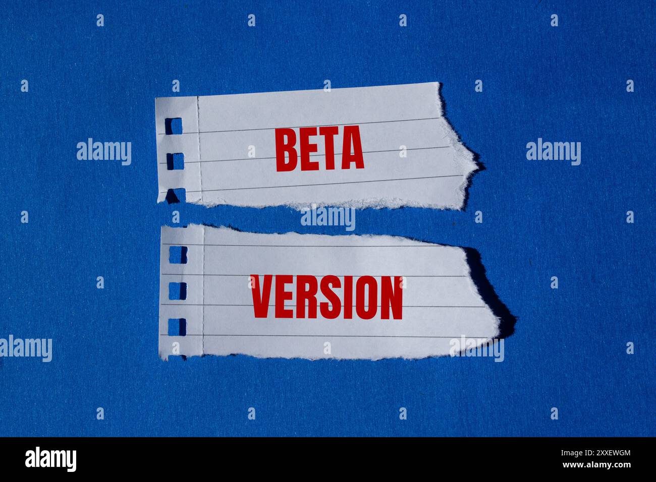 Beta version message written on ripped torn paper pieces with blue ...