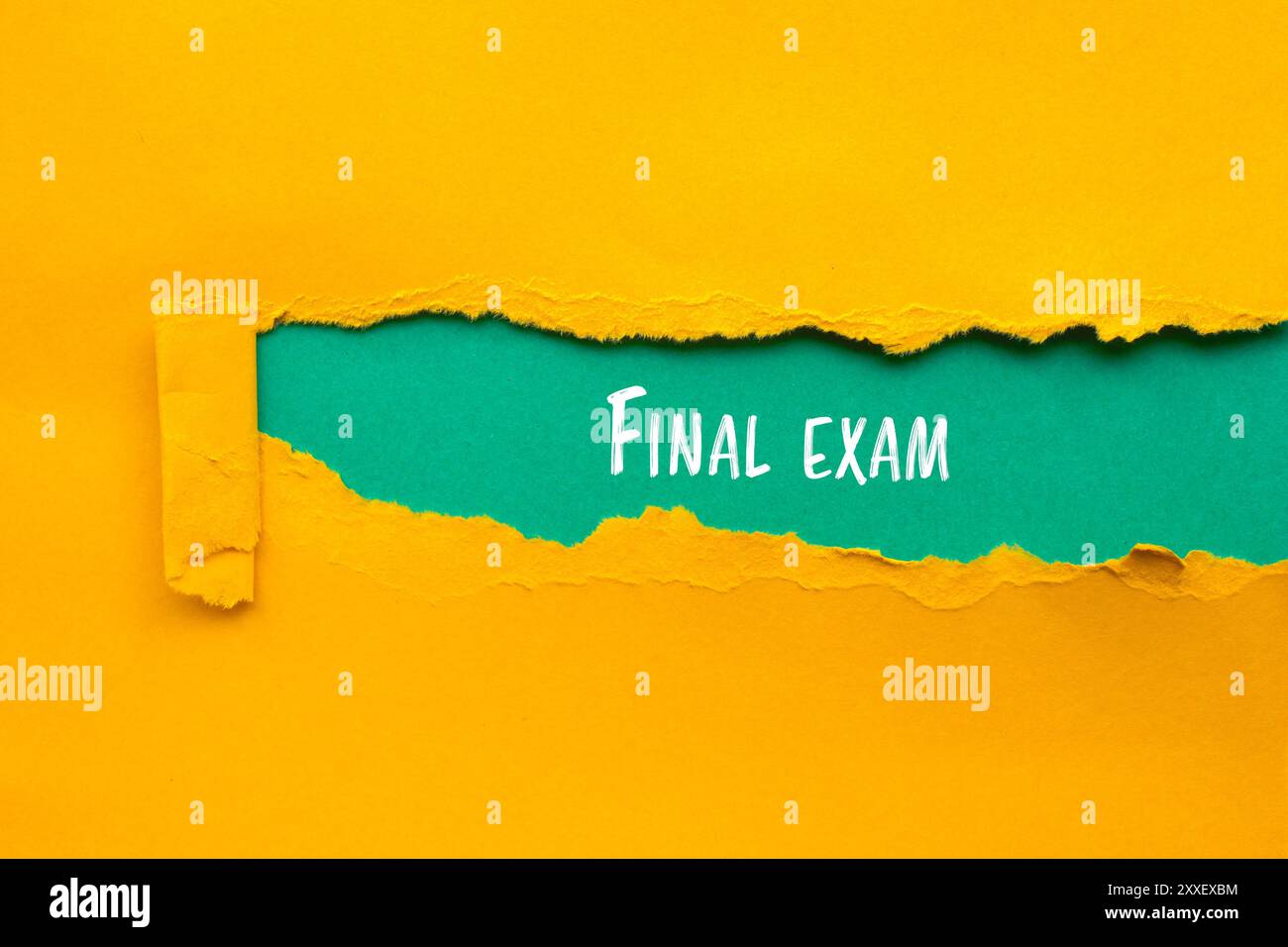 Final exam message written on ripped torn yellow paper with blue ...