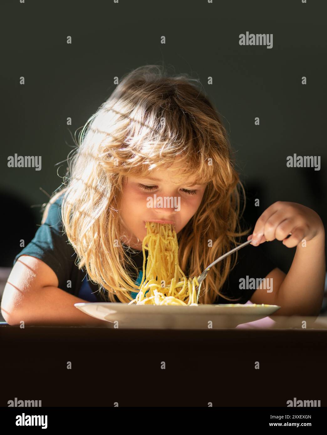 Tasty food, messy child eating spaghetti. Cute child eating breakfast ...