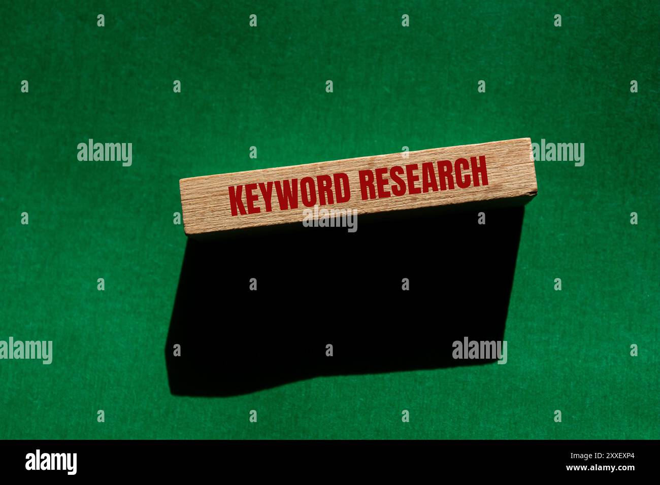 Keyword research message written on wooden block with green background ...