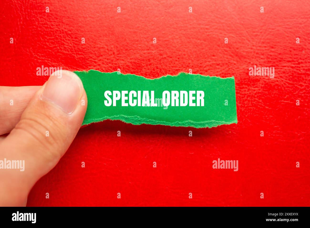 Special order message written on ripped torn green paper with red background. Conceptual special ...