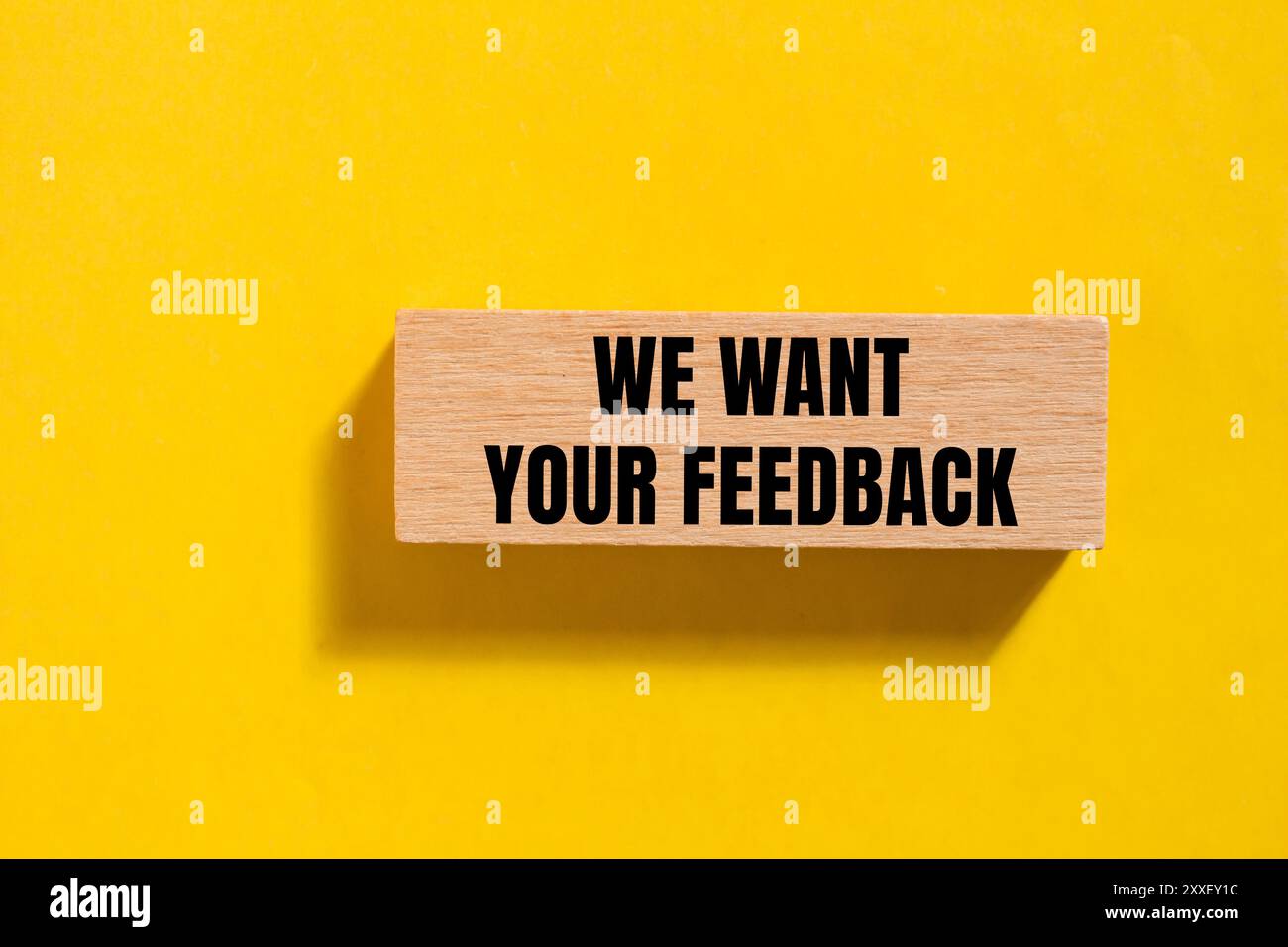 We want your feedback message written on single wooden block with ...