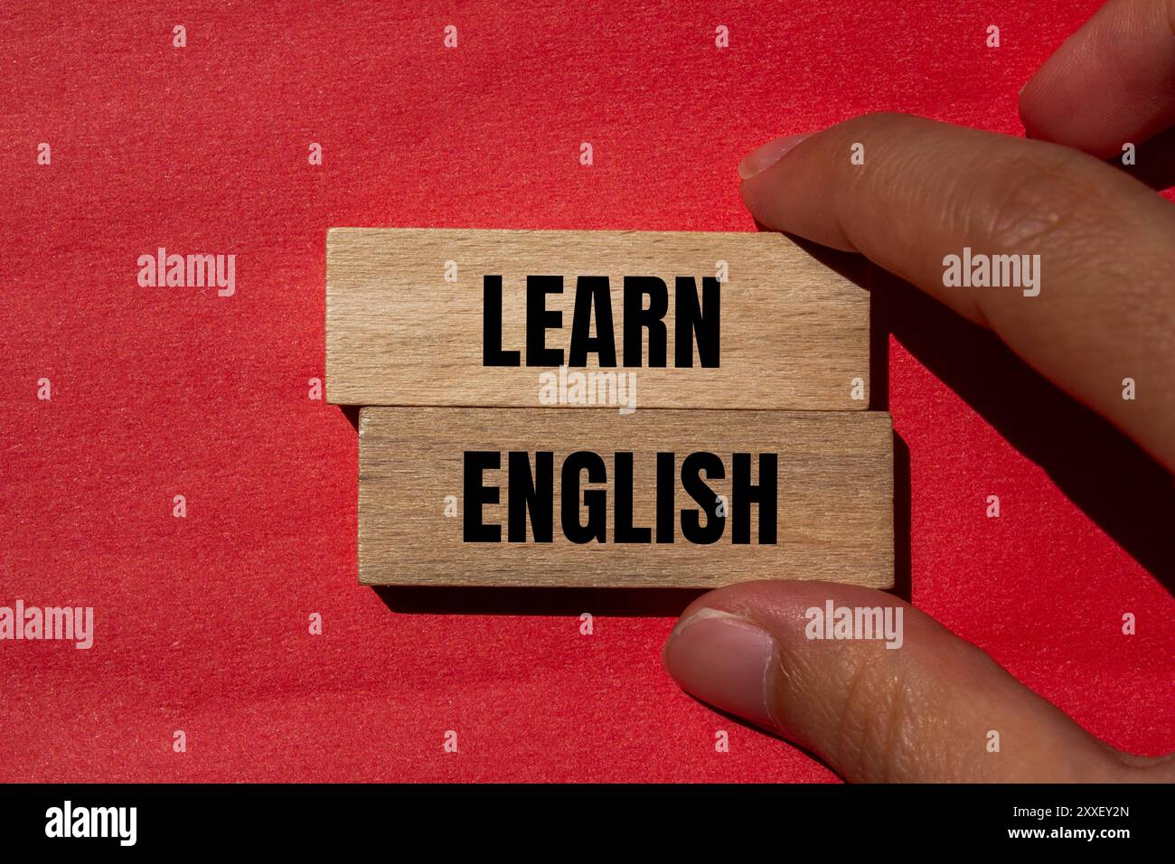 Learn english message written on wooden blocks with red background ...