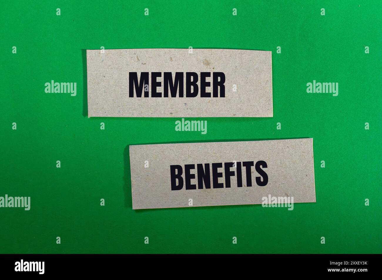 Member benefits message written on paper pieces with green background. Conceptual member ...