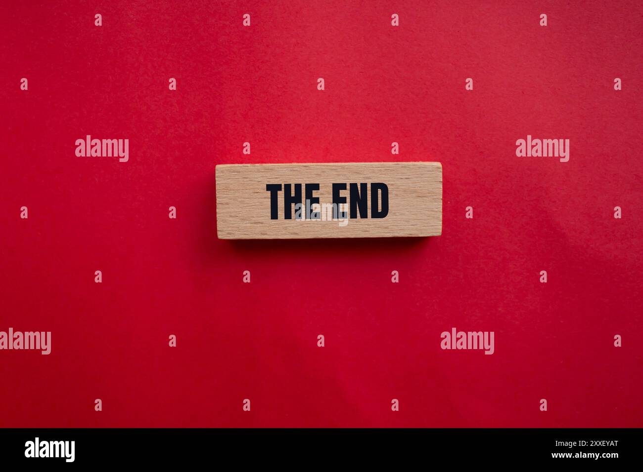 The end message written on wooden block with redbackground. Conceptual ...
