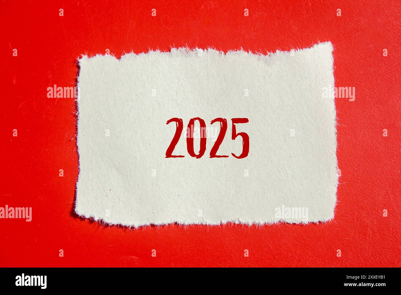 2025 message written on ripped torn paper piece with red background. Conceptual 2025 symbol ...