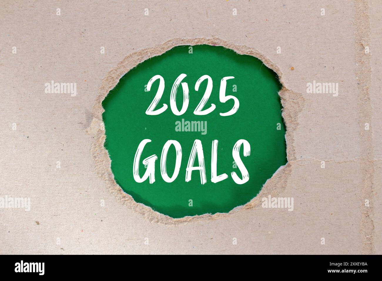 2025 goals message written on ripped torn paper with green background ...