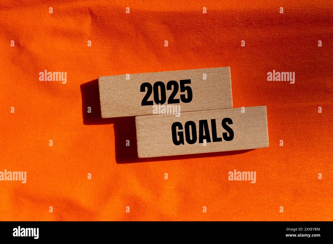 2025 goals message written on wooden blocks with orange background ...