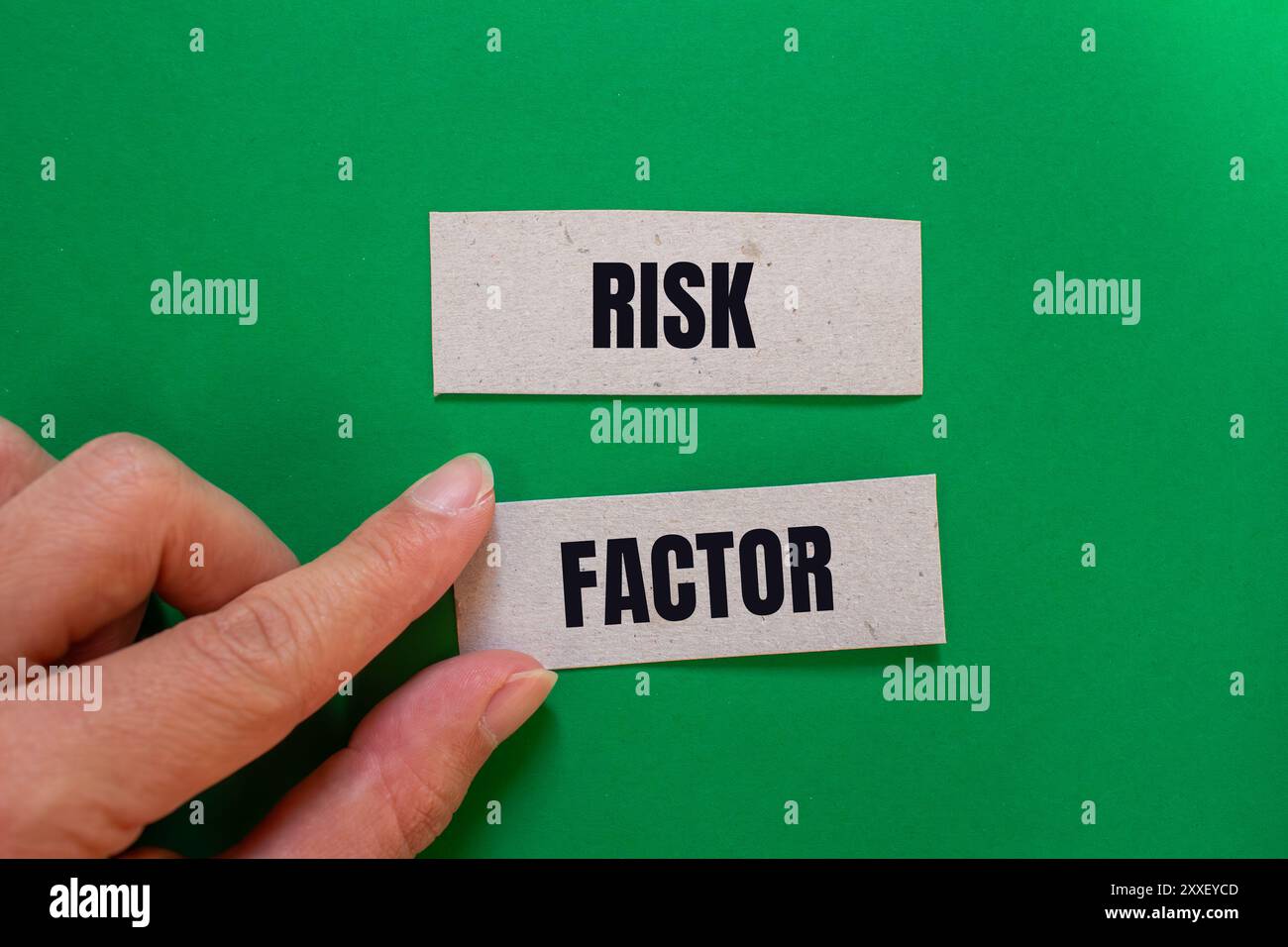Risk factor message written on paper pieces with green background ...