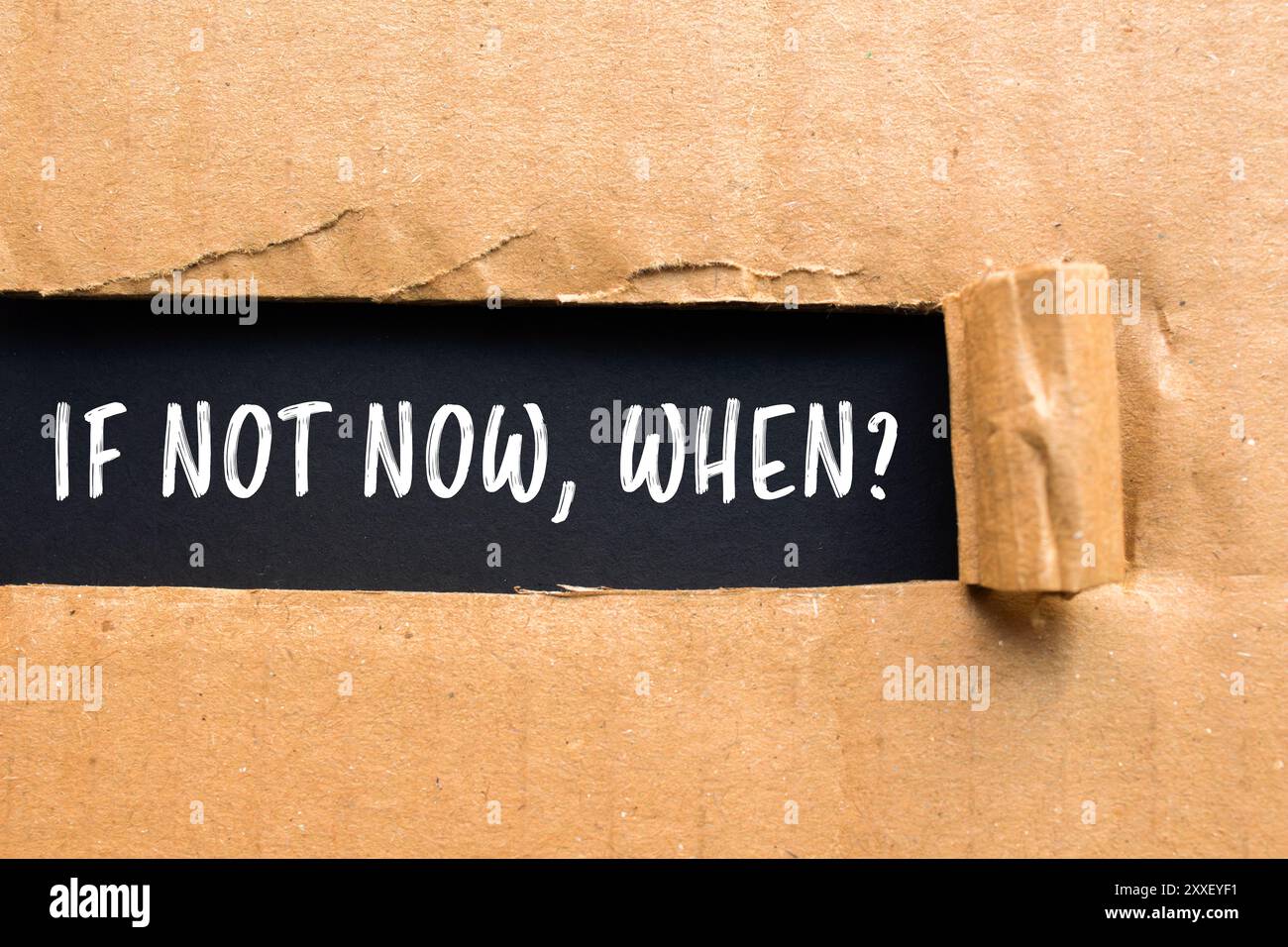 If not now, when question written on ripped torn cardboard paper with ...