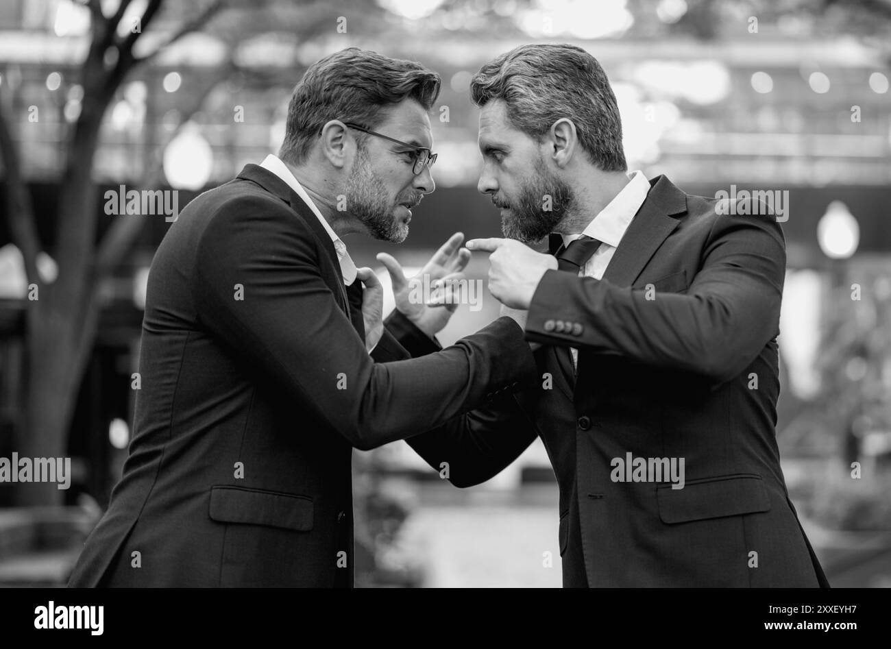 Business men aggressive fight outdoor. Conflict and fight business ...