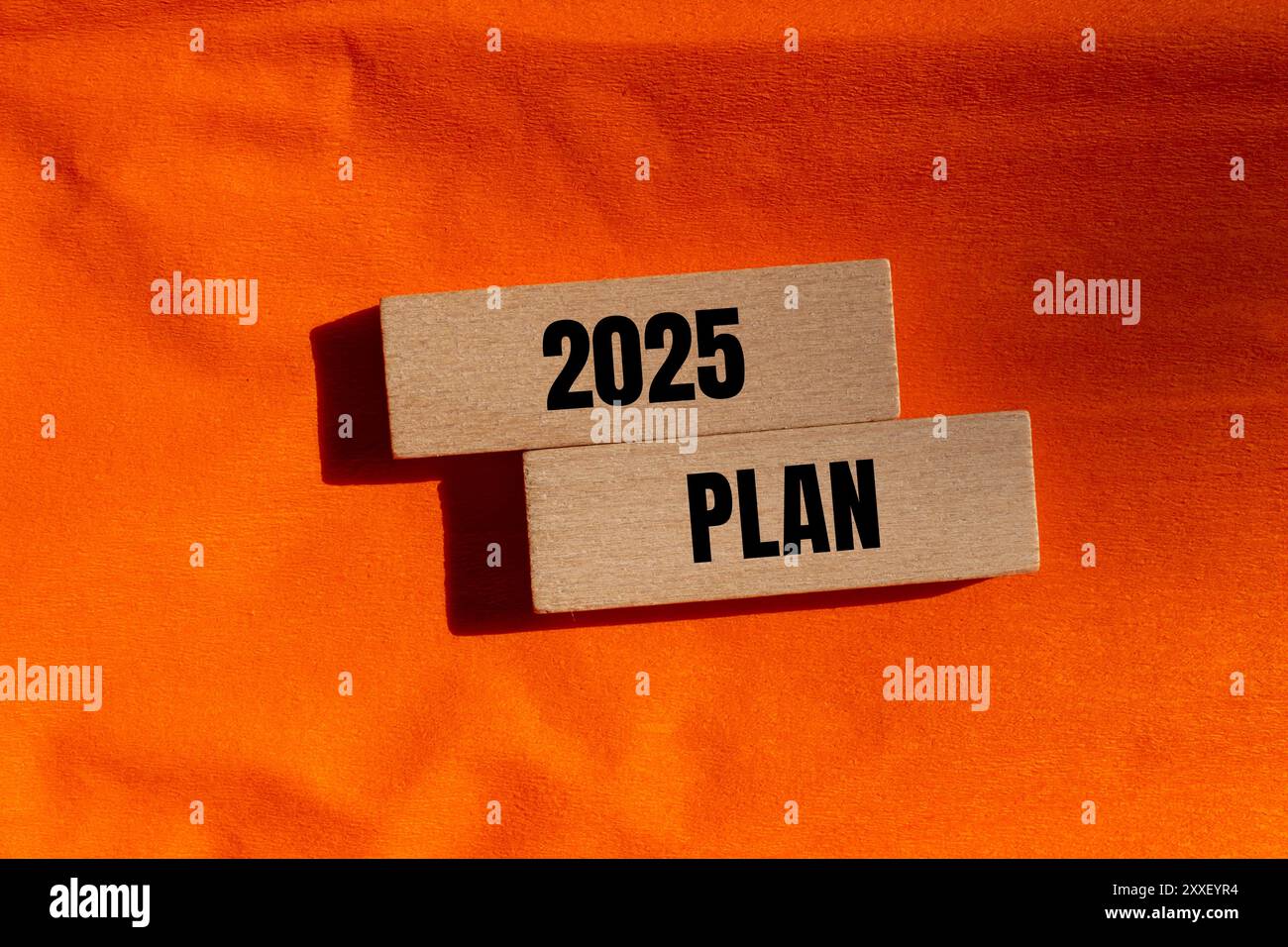 2025 plan message written on wooden blocks with orange background ...