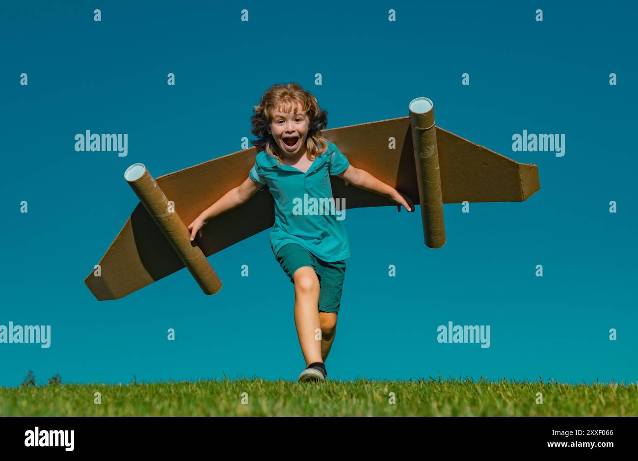 Excited kid with jet pack superhero. Child pilot running against summer ...